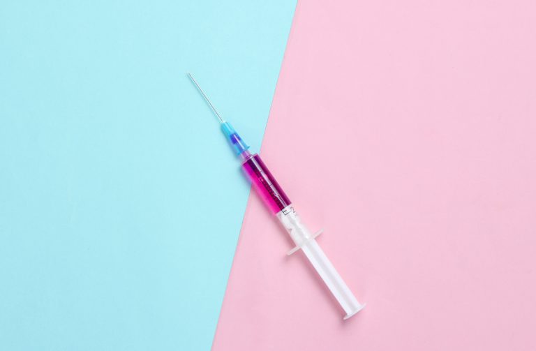 Minimalism medical concept, injection, vaccination. Syringe with purple ...